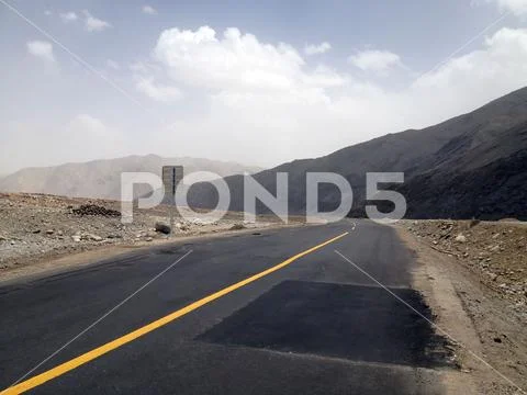 Photograph: A long highway that has a very wide line through the desert ...