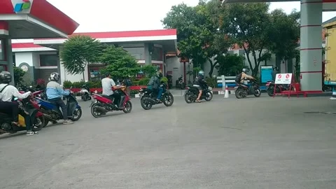 Long queue of motorbikes at gas stations | Stock Video | Pond5