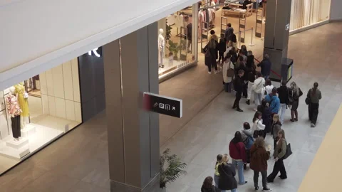 Long queue of people waiting to enter st... | Stock Video | Pond5