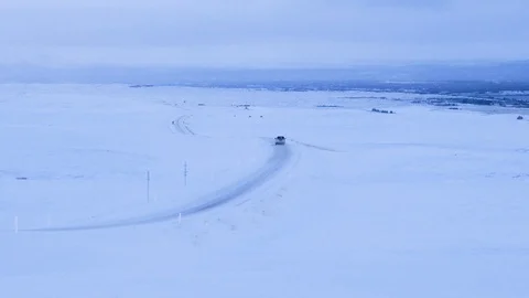 Long shot of a car driving on ice snow o... | Stock Video | Pond5