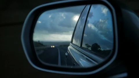 Looking back in the side review mirror. ... | Stock Video | Pond5