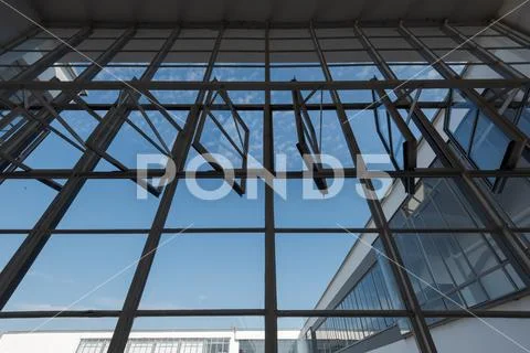 Photograph: Looking up at big window front with partially opened ...