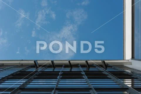 Looking up at big window front with partially opened windows of the ...