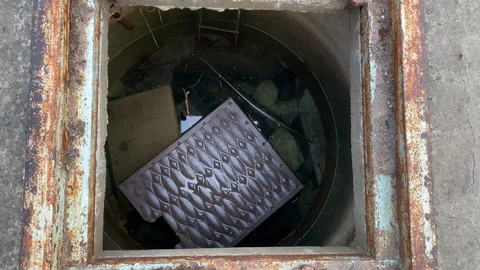 Looking down into an open manhole showin... | Stock Video | Pond5