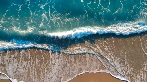 Looking down onto waves on the beach | Stock Video | Pond5