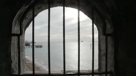 Looking out to sea through prison bars | Stock Video | Pond5
