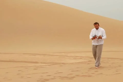 Lost man looking at map in the desert | Stock Video | Pond5