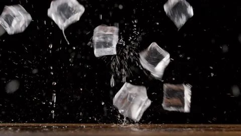 Lot of ice cubes rapidly falling down on... | Stock Video | Pond5