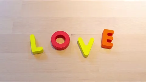 Love text stop motion animation on wood ... | Stock Video | Pond5