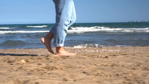 Low angle: Girl walking and stepping ove... | Stock Video | Pond5