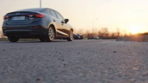 Low-angle ground shot of black car drivi... | Stock Video | Pond5