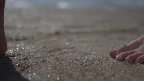 Low angle on man walking, stepping at be... | Stock Video | Pond5