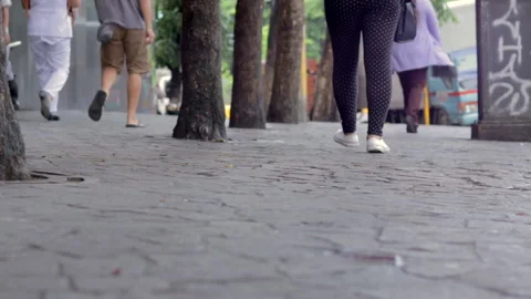 Low angle static shot, people walking in... | Stock Video | Pond5