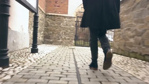 a low follow shot of a man walking down ... | Stock Video | Pond5