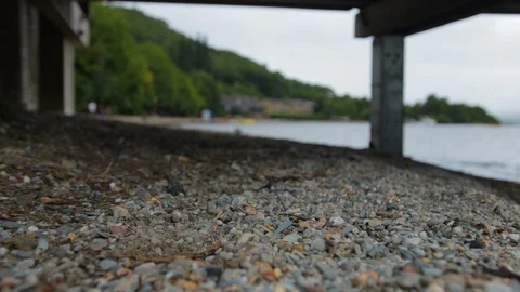 Low ground shot on the beach walking und... | Stock Video | Pond5