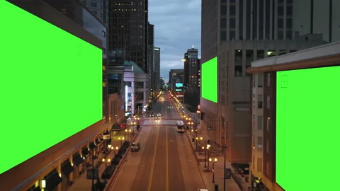 Low over streets with green screens on b... | Stock Video | Pond5