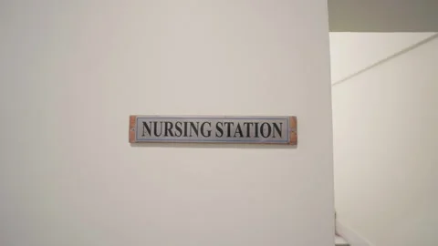 low zoom-in on "Nursing Station" wall si... | Stock Video | Pond5