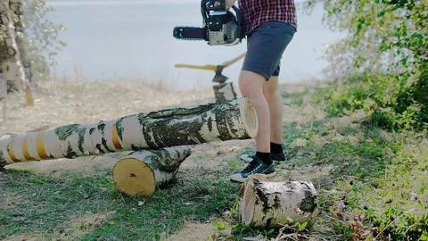 A lumberjack gets to work, starts the ch... | Stock Video | Pond5