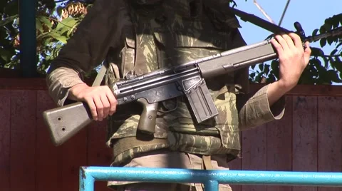 Machine gun, tilt up to young man, a Gre... | Stock Video | Pond5