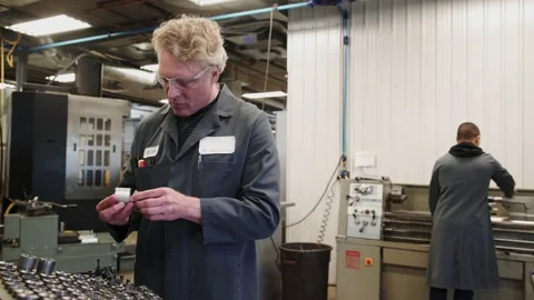 Machine shop worker examining machine pa... | Stock Video | Pond5