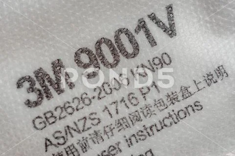 Photograph: Macro photo of face shield 3m 9001v Kn90 1716 P1 with original marking closeu #129435732