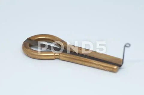 Macrophotography of an old jaw harp - isolated on white background ...