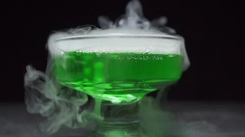 Magic potion is brewed in a glass bowl o... | Stock Video | Pond5