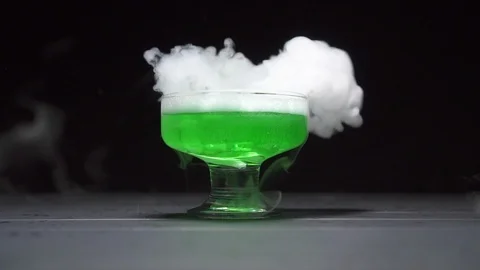Magic potion is brewed in a glass bowl o... | Stock Video | Pond5