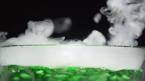 Magic potion is brewed in a glass bowl o... | Stock Video | Pond5
