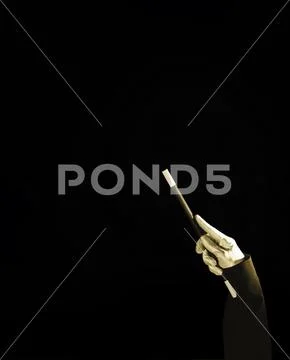 Magician s hand holding magic wand against black background ~ Premium ...