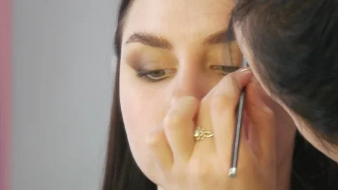 Make-up artist applies modern make-up on... | Stock Video | Pond5