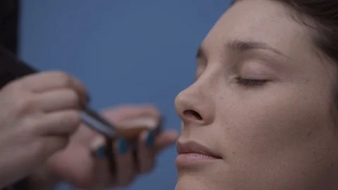 Make up artist applying powder on a mode... | Stock Video | Pond5