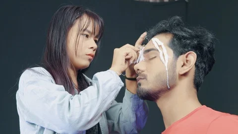 Make up artist applying white prosthetic... | Stock Video | Pond5