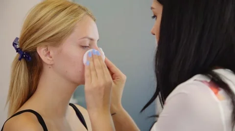 Make-up artist cleaning skin on model's ... | Stock Video | Pond5