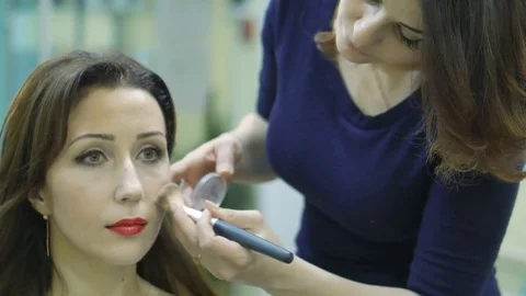 make-up artist doing a model's makeup at... | Stock Video | Pond5