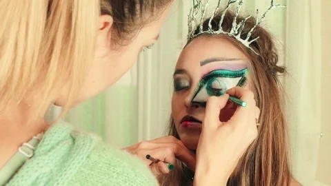 Make-up artist makes the girl face-art m... | Stock Video | Pond5