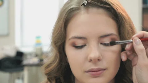 Makeup artist making make-up for a young... | Stock Video | Pond5