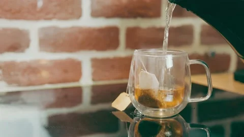 Making tea in a bag in a transparent gla... | Stock Video | Pond5