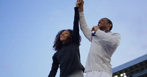 Male and Female Athletes Celebrate a Win... | Stock Video | Pond5