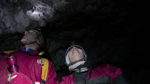 Male and female cave explorers looking a... | Stock Video | Pond5