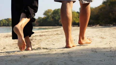 Male and female legs of pair walking on ... | Stock Video | Pond5