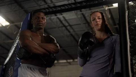 Male and female MMA fighters stare at ca... | Stock Video | Pond5