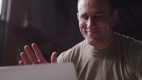 Male Army Soldier Sits on Cot and Waves ... | Stock Video | Pond5