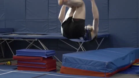 Male athlete doing backflip in gymnasium | Stock Video | Pond5