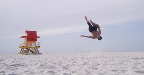 Male athlete performing a backflip on th... | Stock Video | Pond5