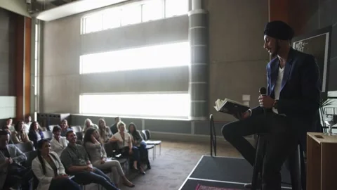 Male author reading from book on stage a... | Stock Video | Pond5