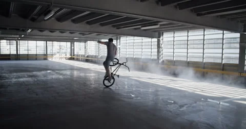 Male BMX rider spinning on rear wheel of... | Stock Video | Pond5