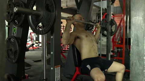 Male bodybuilder sit up on the bar chair... | Stock Video | Pond5