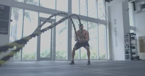 Male bodybuilder training with battle ro... | Stock Video | Pond5