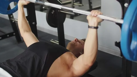 Male bodybuilder trains in gym with barb... | Stock Video | Pond5